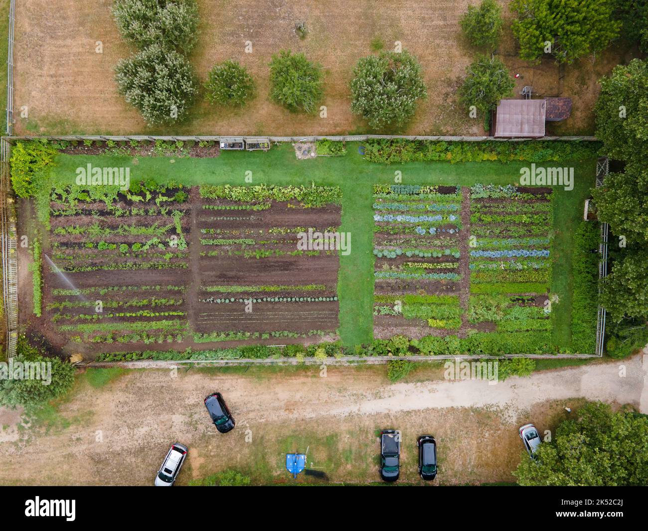 A high angle of a farm land with cars below Stock Photo - Alamy