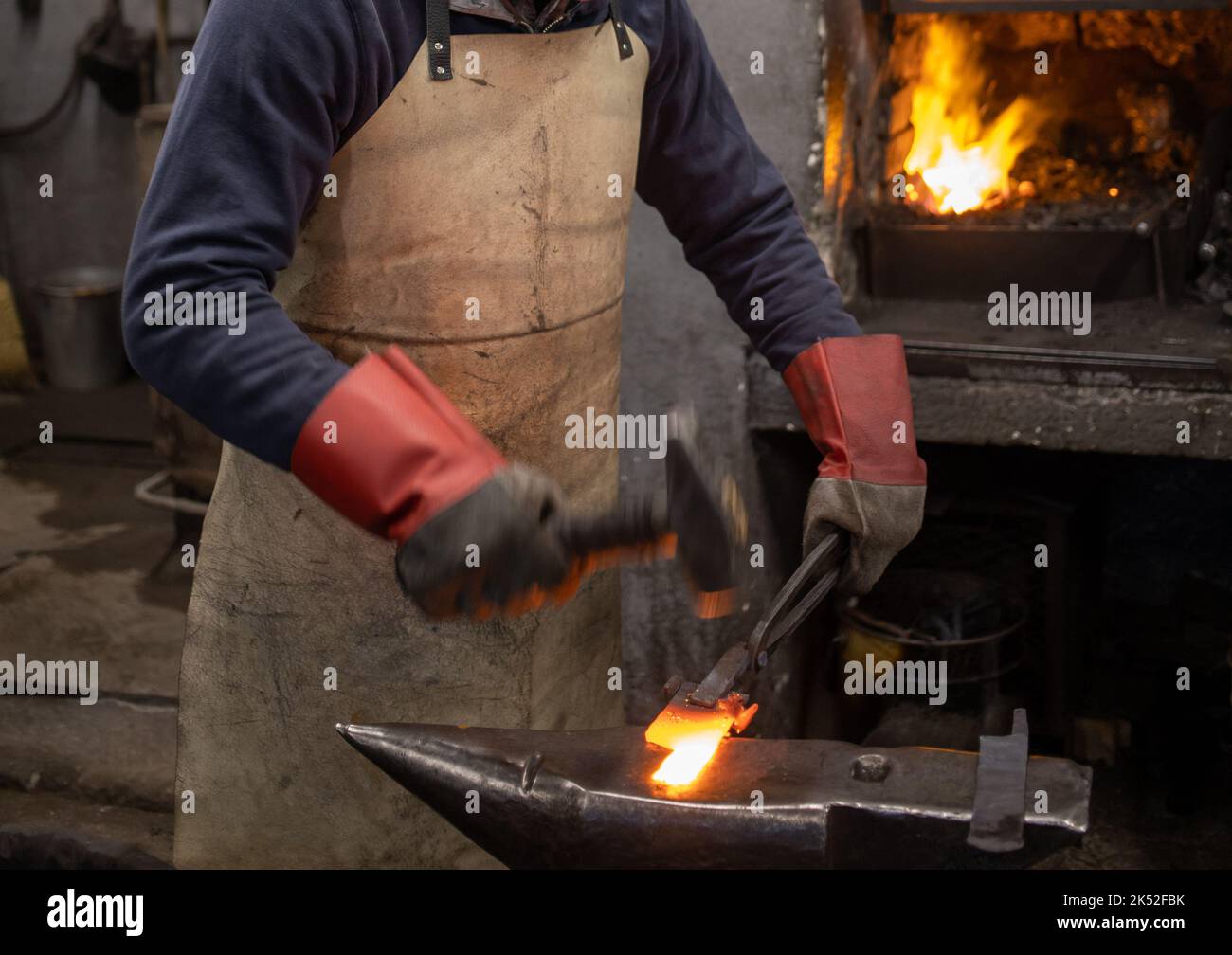 blacksmith forging with hammer blank metal part Stock Photo - Alamy