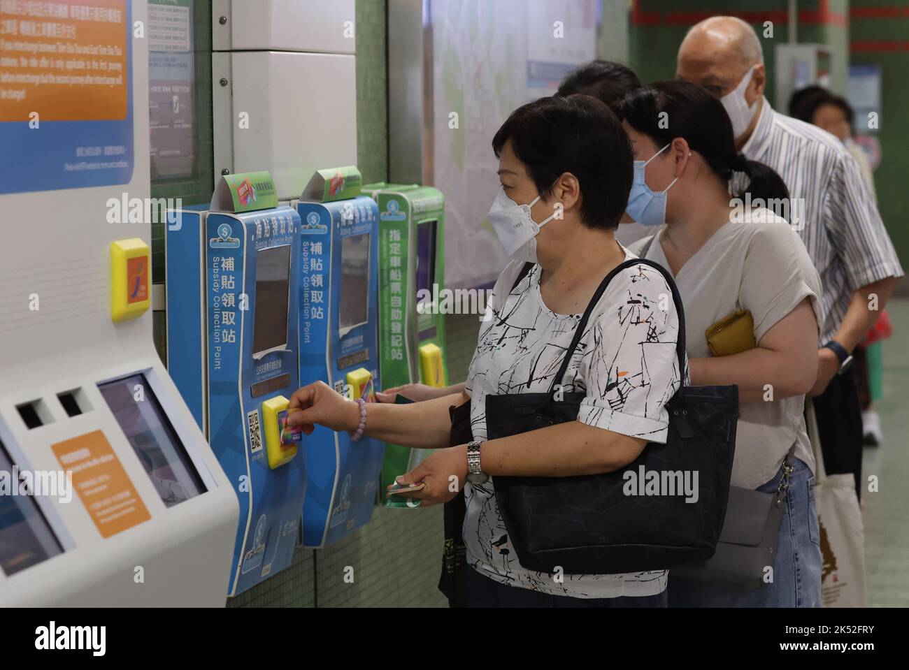 People line up to collect their consumption vouchers (by tapping their ...