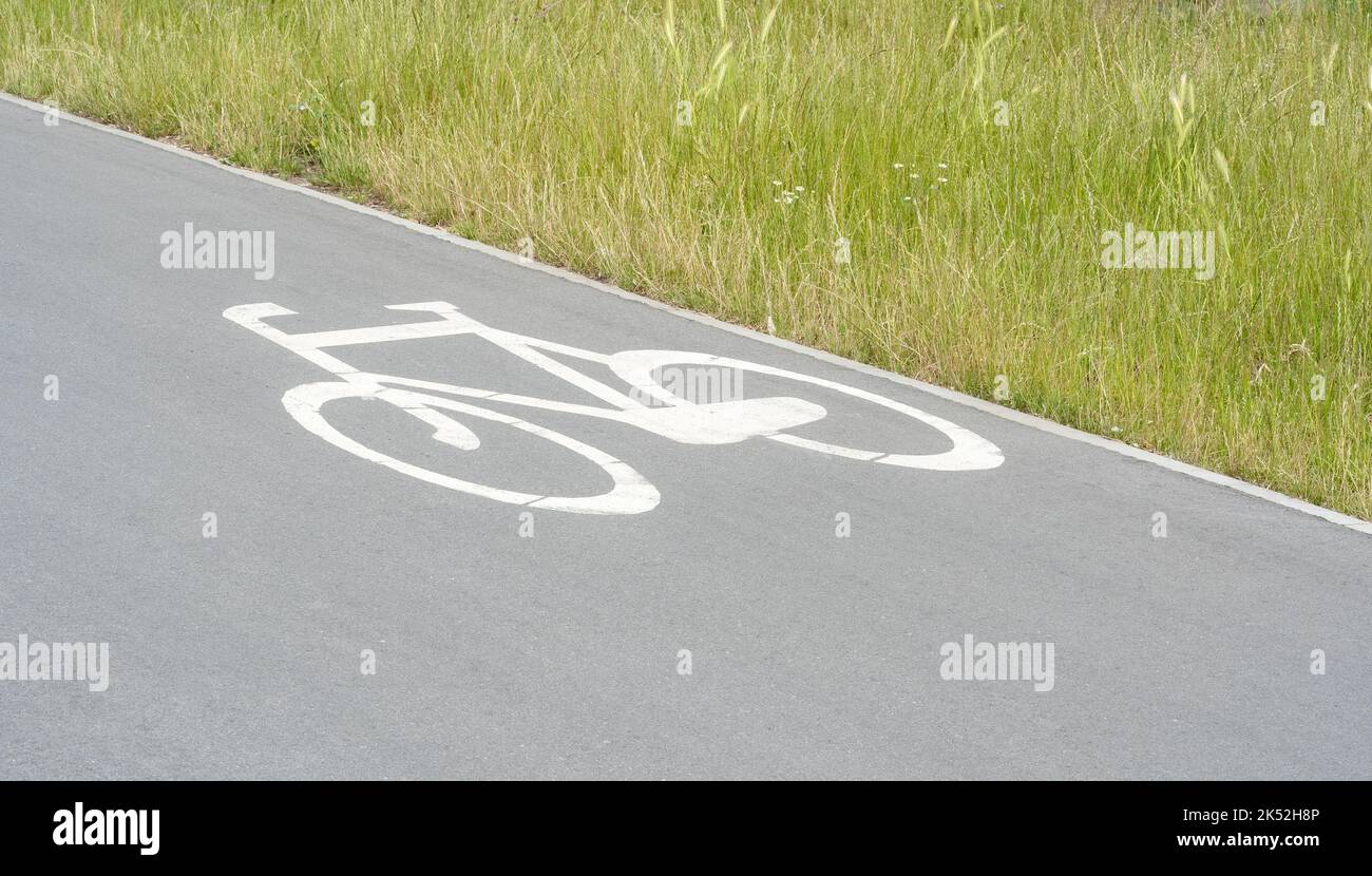 Bike lane sign on the ground, simple white bike symbol painted on the ...