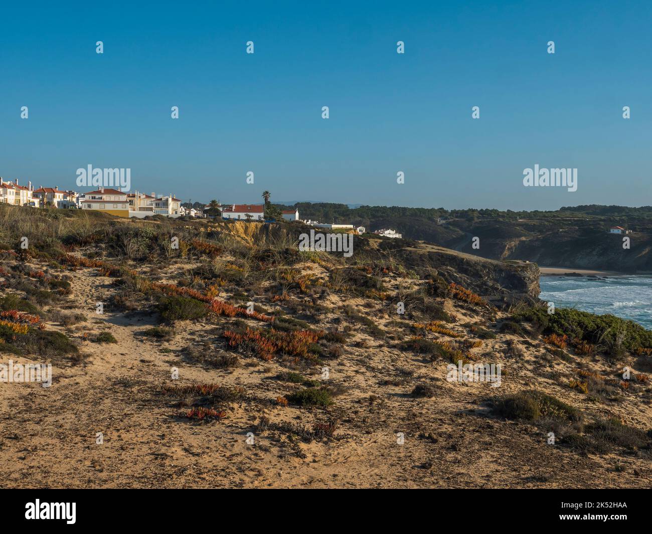 View of Zambujeira do Mar over the sea shore with ocean waves, cliffs ...