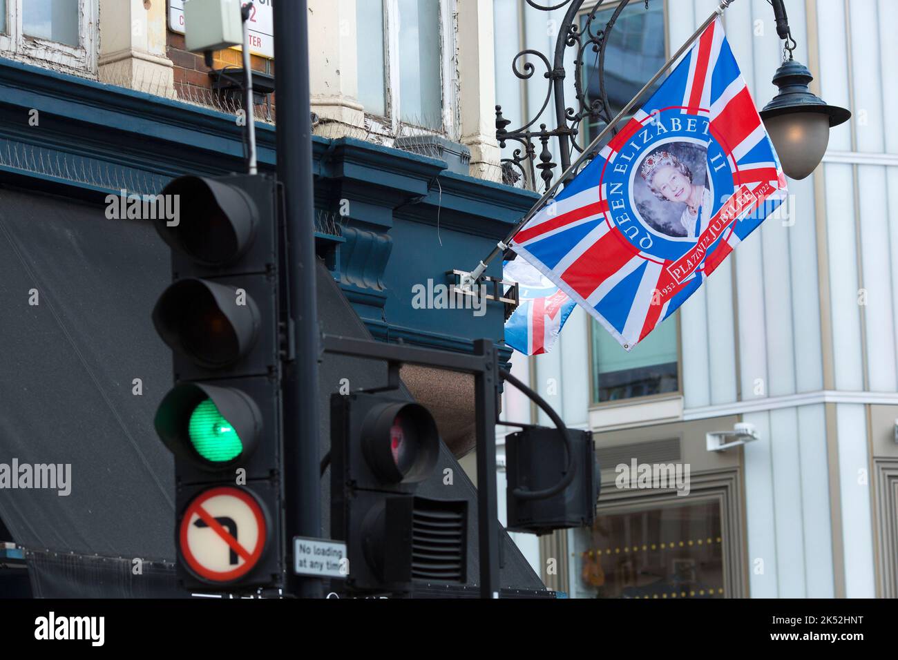 A Union flag featuring a portrait of Britain’s Queen Elizabeth II is ...