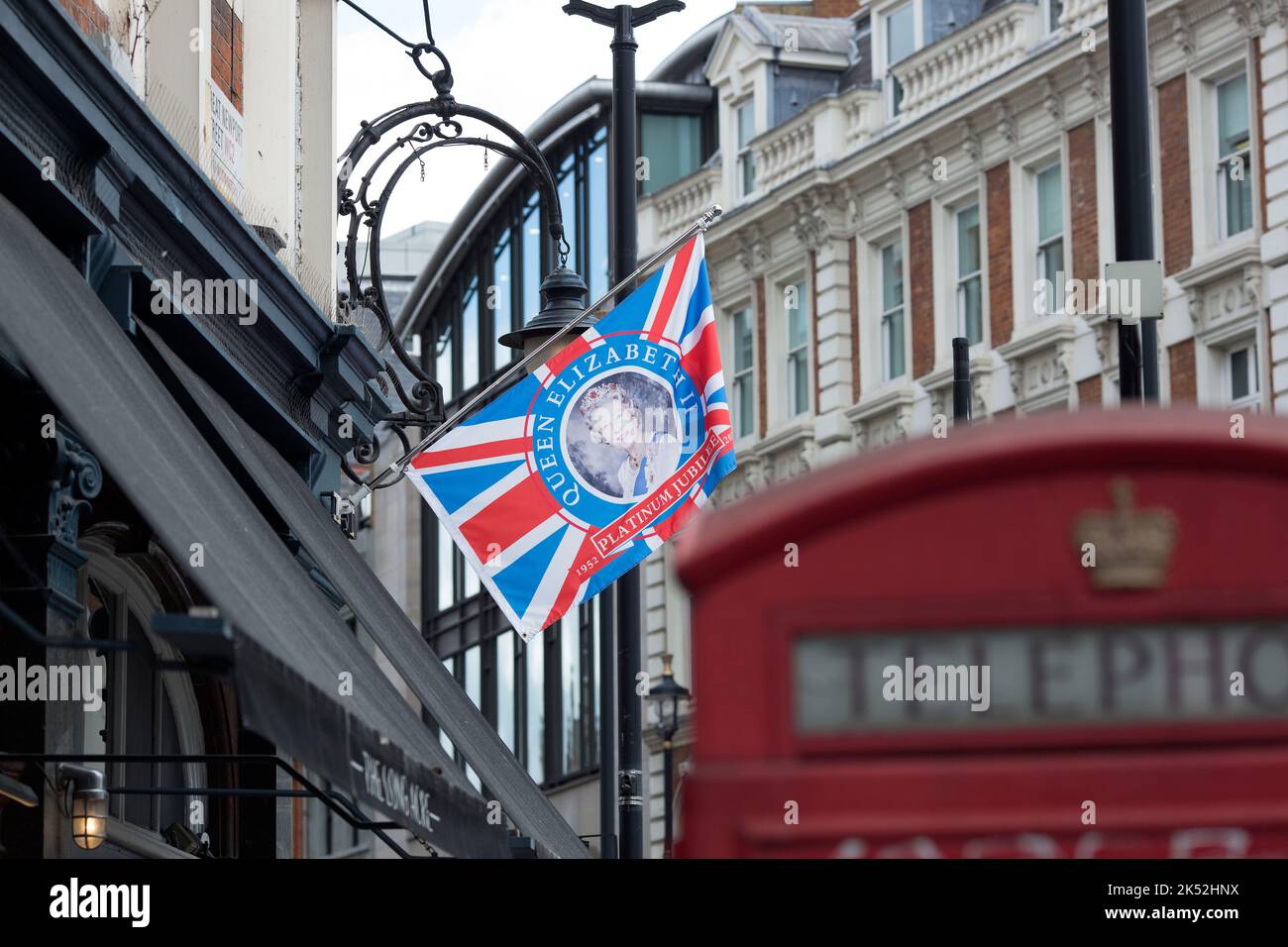 A Union flag featuring a portrait of Britain’s Queen Elizabeth II is ...