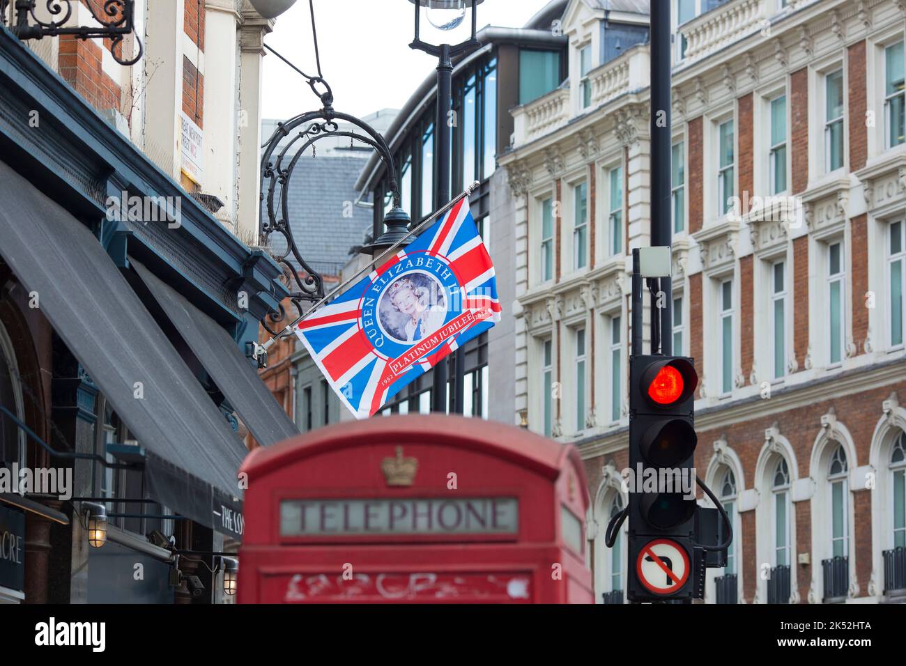 A Union flag featuring a portrait of Britain’s Queen Elizabeth II is ...