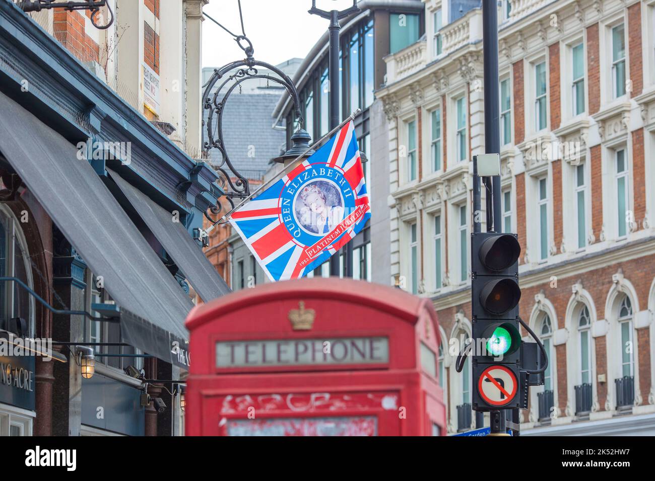 A Union flag featuring a portrait of Britain’s Queen Elizabeth II is ...