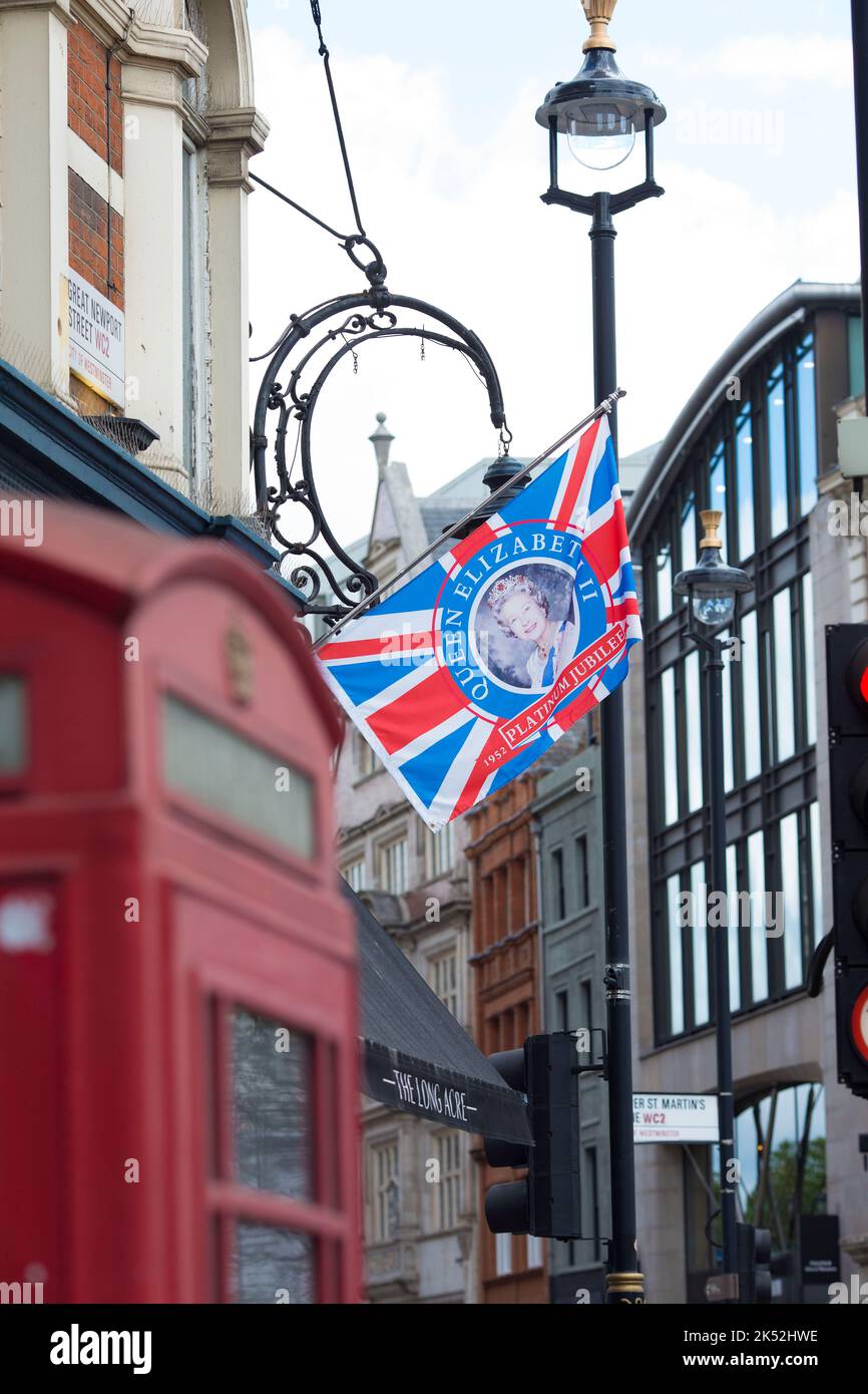 A Union flag featuring a portrait of Britain’s Queen Elizabeth II is ...