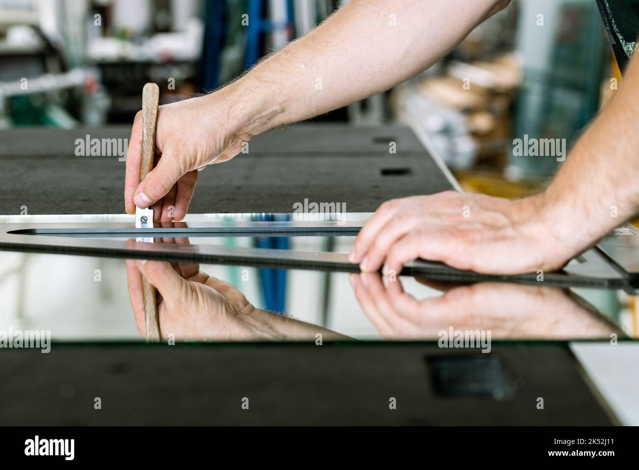 Glazier cuts a mirror on a special table, Glass industry Stock Photo ...
