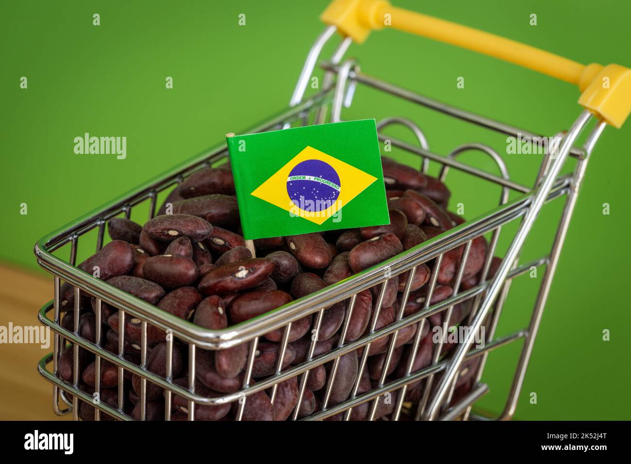 A miniature shopping cart full of beans with the Brazilian flag stuck ...