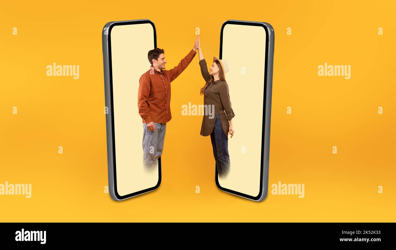 Couple In Big Smartphones Screens Giving High Five, Yellow Background ...