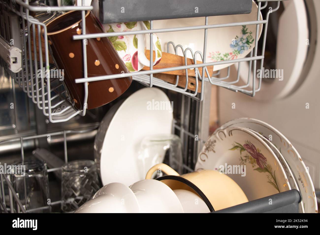 dishwasher with clean dishes at home in the kitchen, washing dishes ...