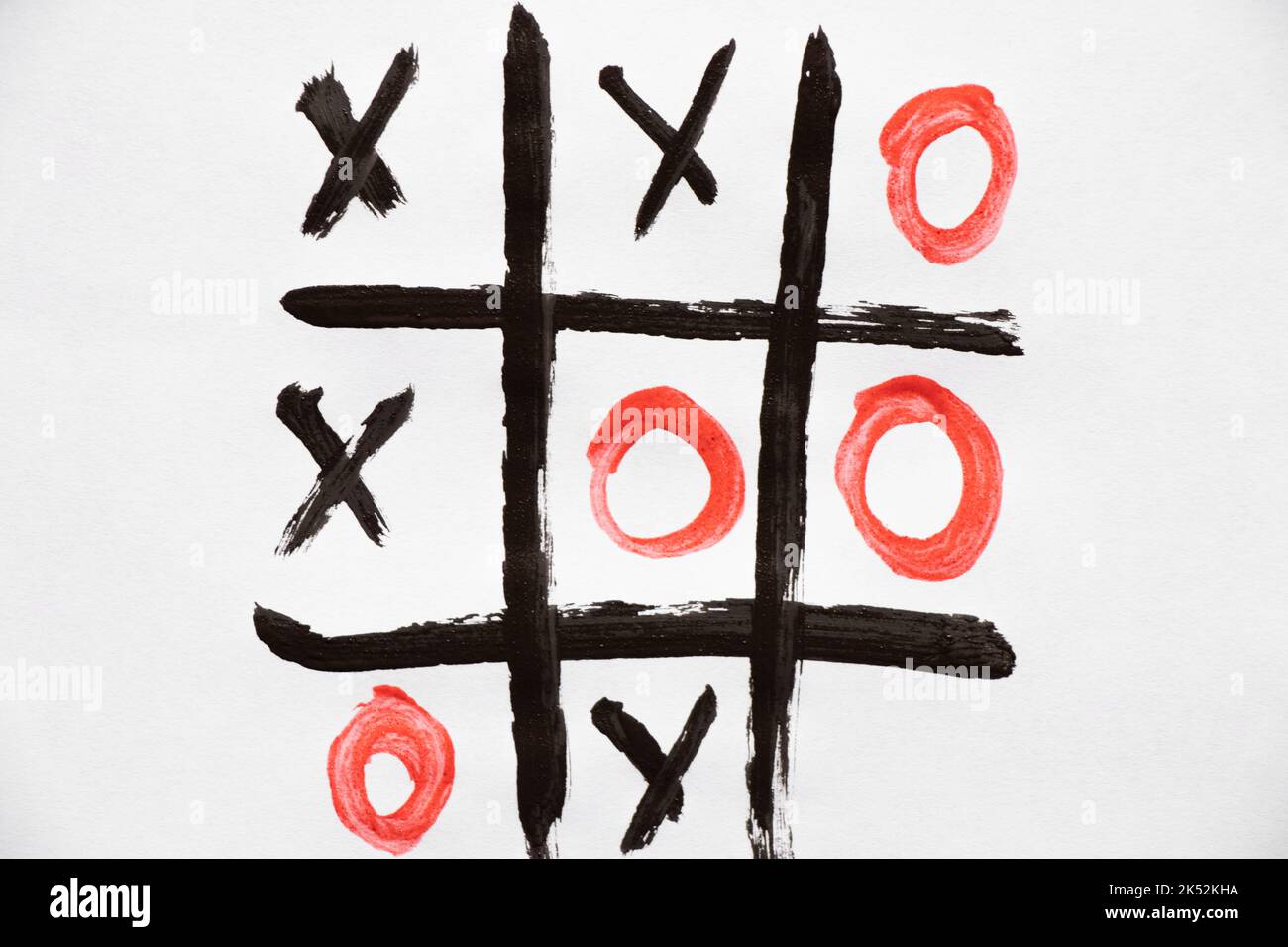 the game of tic-tac-toe is drawn on paints on white paper, play and ...