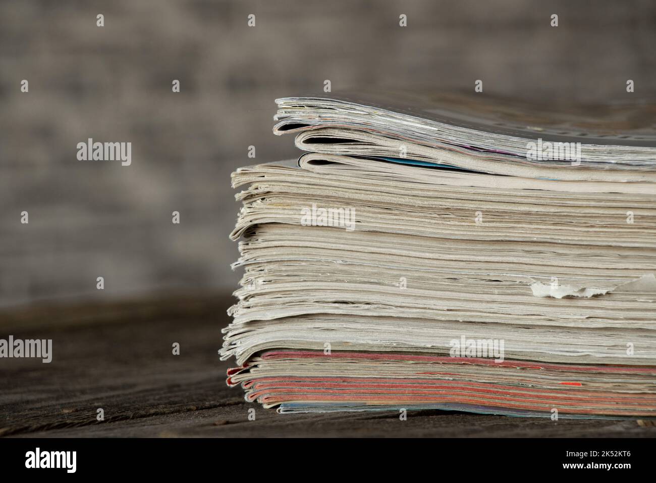 a stack of magazines and newspapers lies on the table, a daily ...