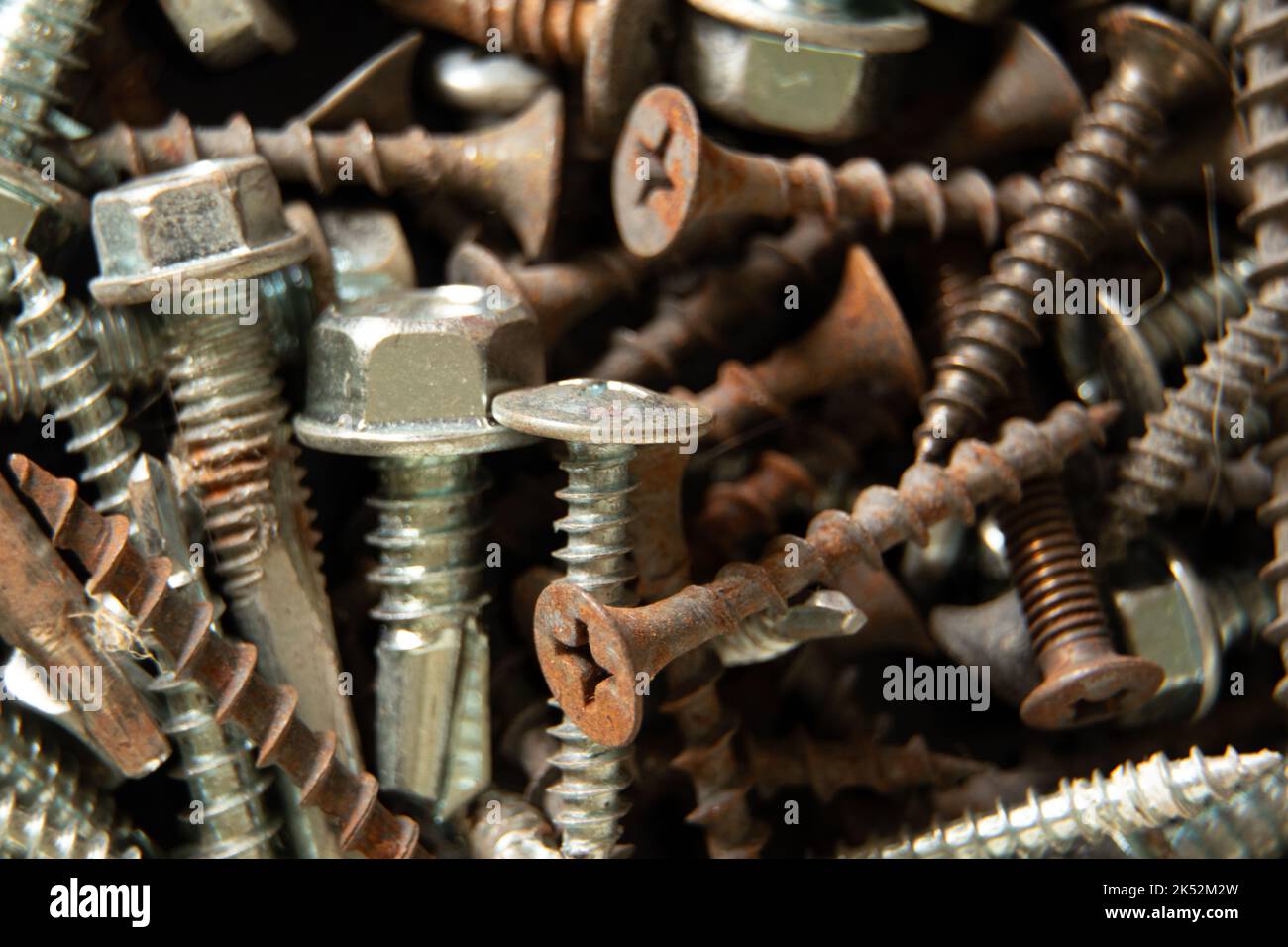 old screws and nuts and screws as background, screws and nails for ...