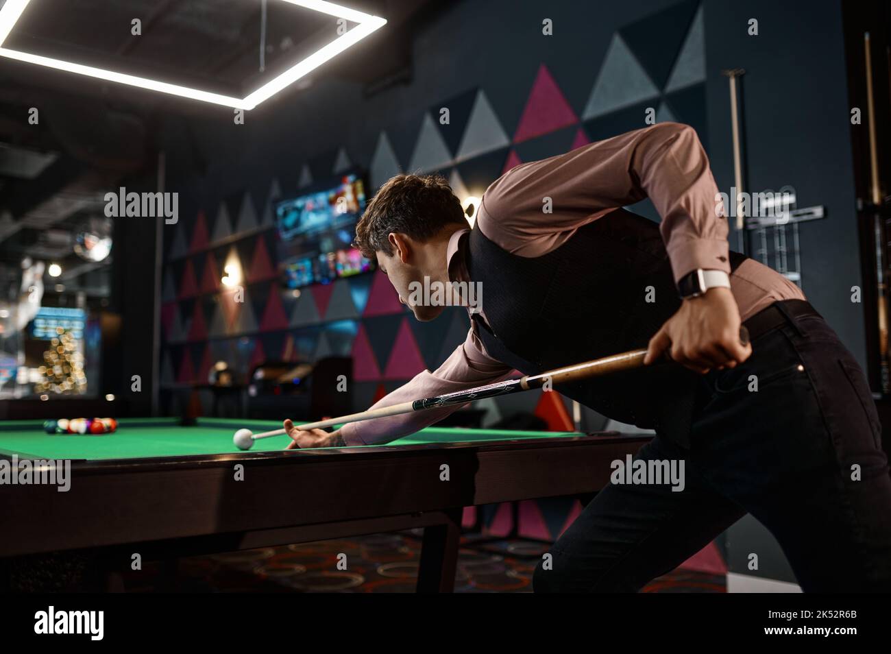 Young man playing billiard at night club Stock Photo - Alamy