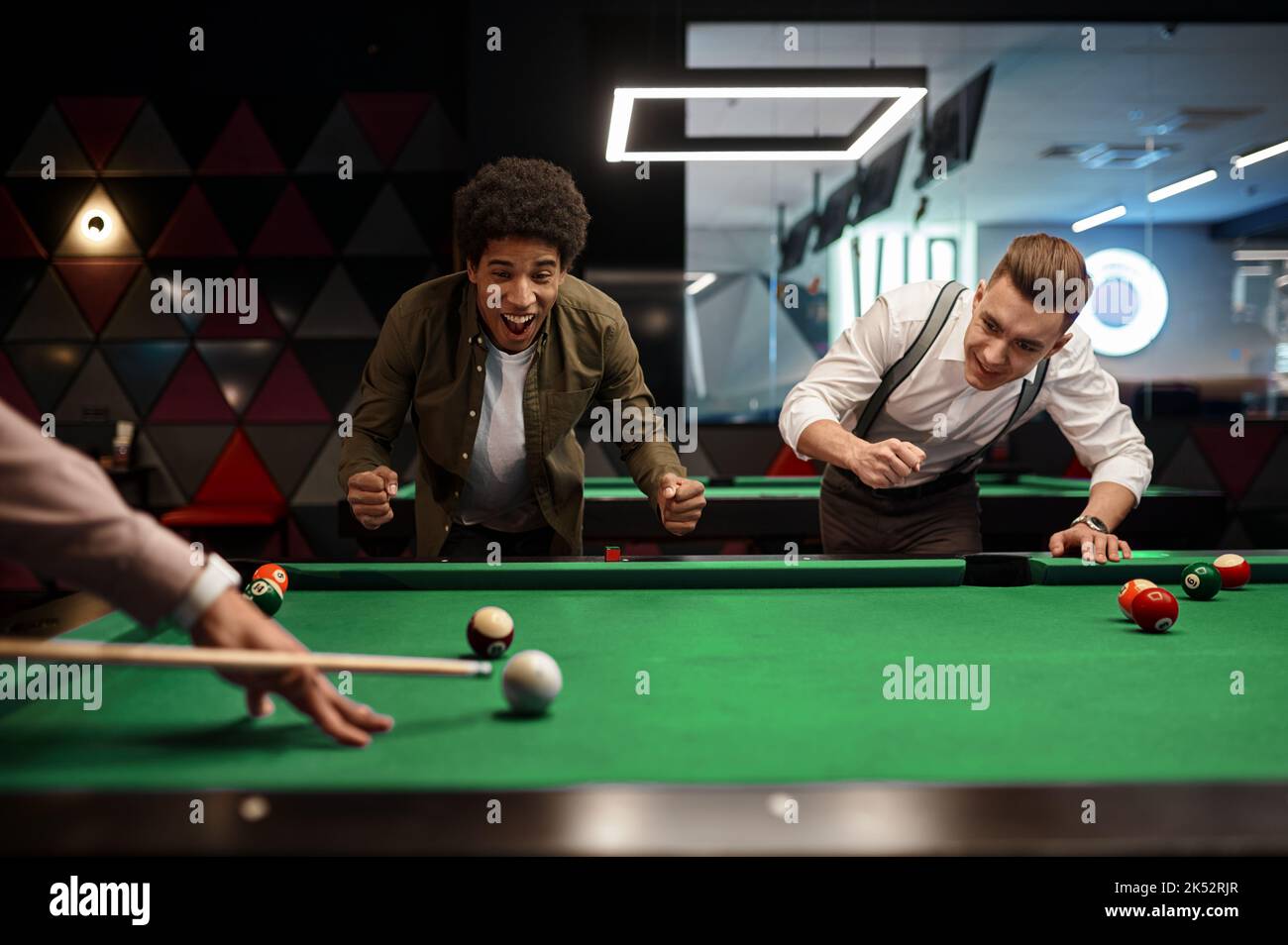 Friends playing billiards together in the club Stock Photo - Alamy