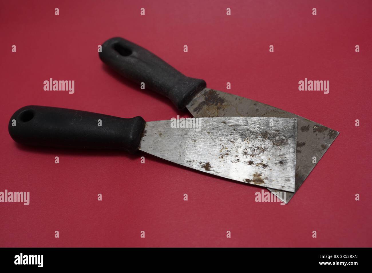 Putty knives with wooden handles, Closeup a new metallic putty knife ...