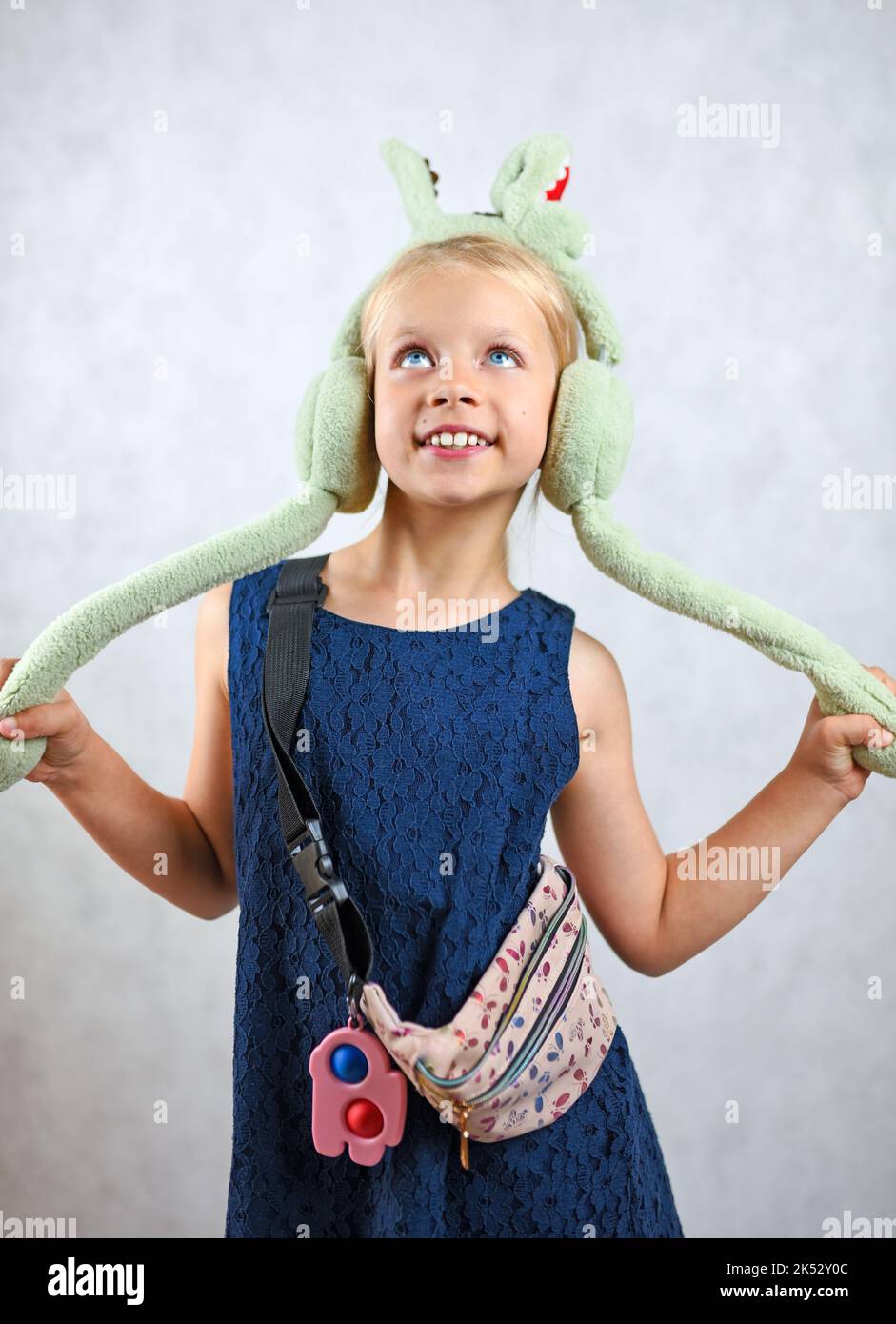 Child in warm headphones shows emotions, funny Stock Photo - Alamy