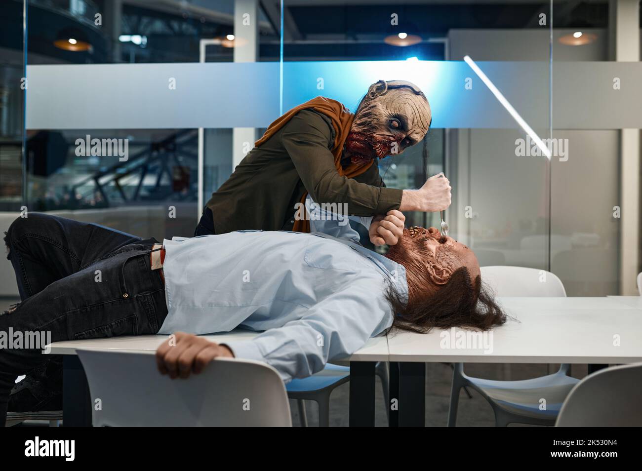 Creepy zombie employee fighting in office dining room Stock Photo - Alamy