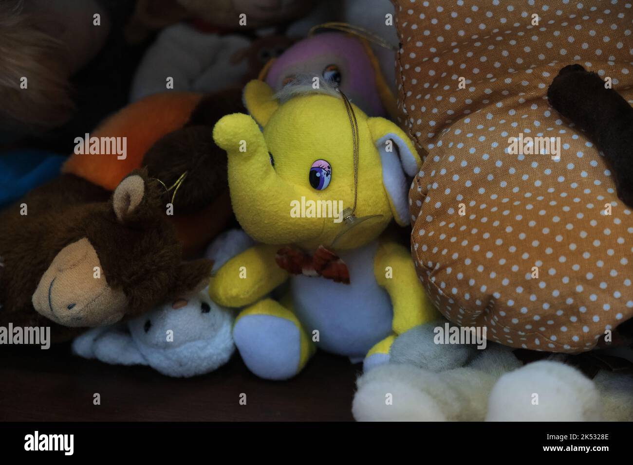 Childrens toy in the shape of a yellow elephant with a toys background ...