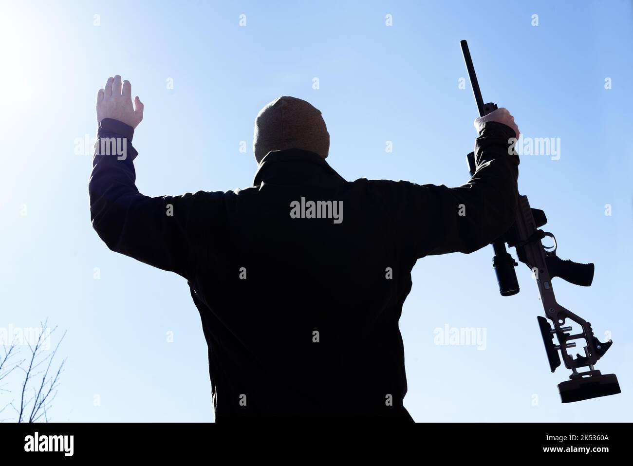 Capitulating soldier sniper rifles with an optical sight in man`s hands ...