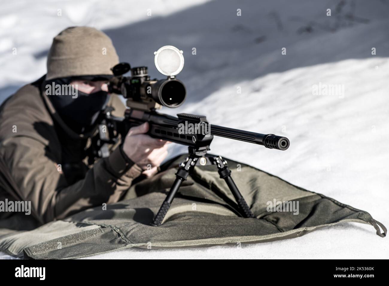 Gun barrel in focus sniper rifles with an optical sight in man`s hands ...