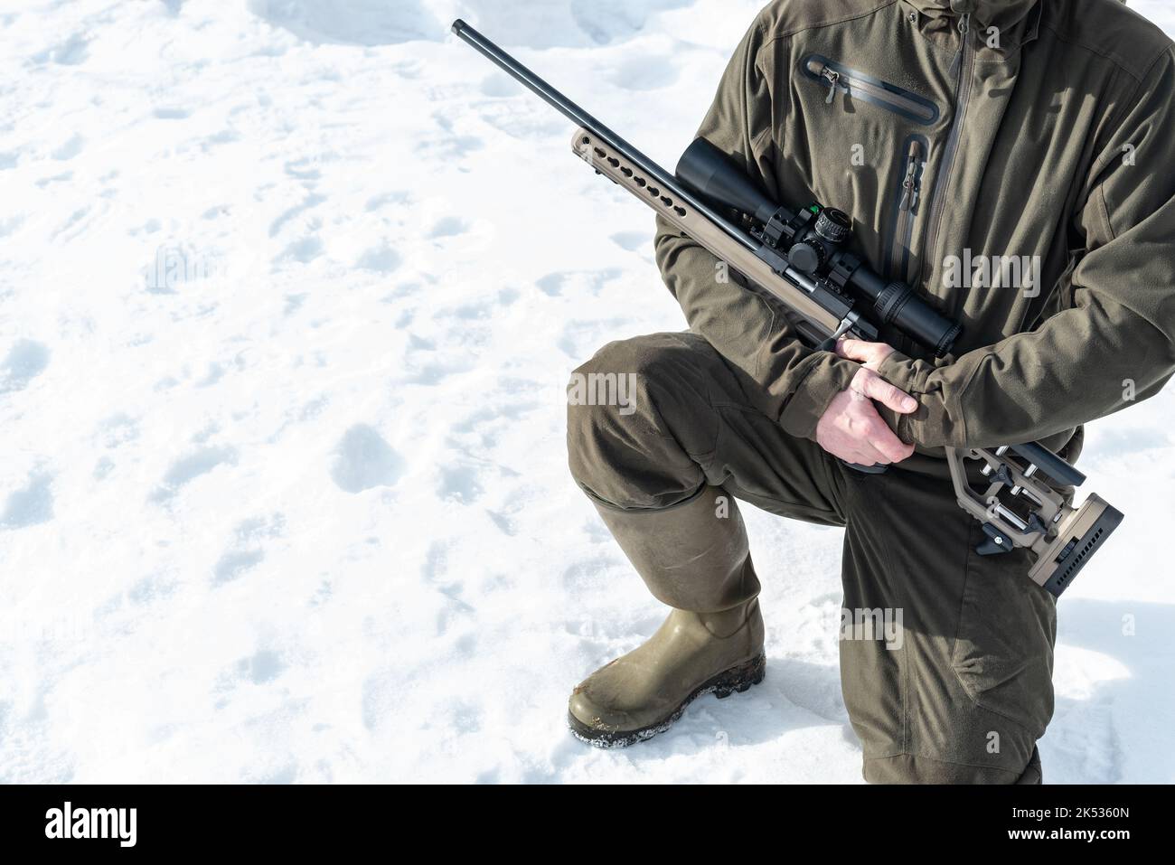 A sniper rifles from a rifle with an optical sight in man`s hands sunny ...