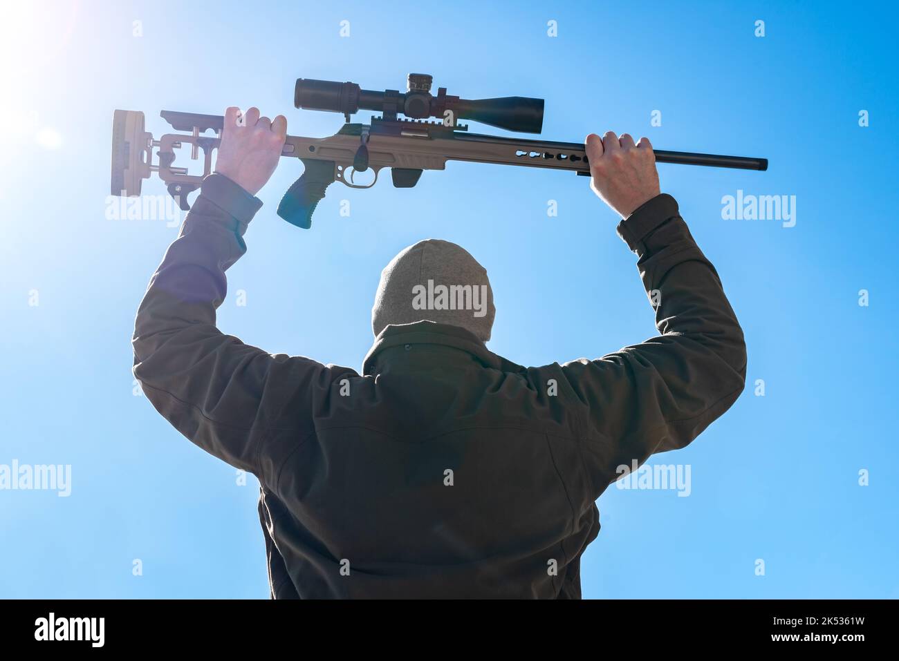 Capitulating soldier sniper rifles with an optical sight in man`s hands ...