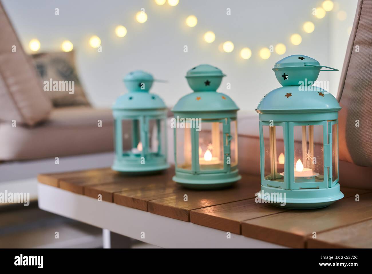 Three mint lamps at night on a table in a modern house balcony Stock ...