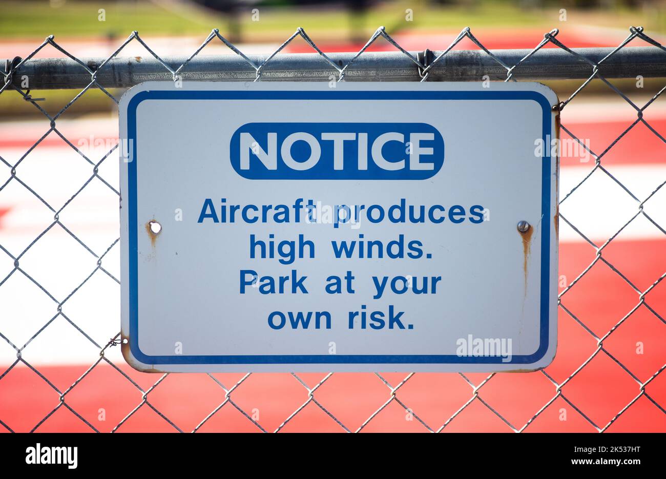 Sign: Notice! Aircraft produces high winds. Park at your own risk Stock ...