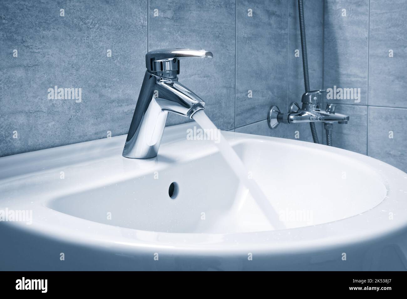 Bathroom water mixer. Water tap made of chrome material, Faucet with water in blue tone Stock ...