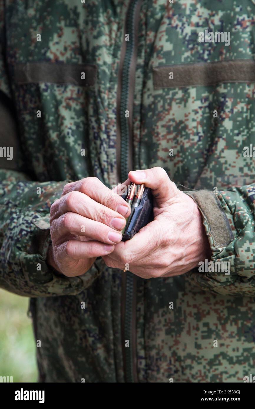 Soldier hands load rifle machine gun bullets into cartridge clip Stock ...