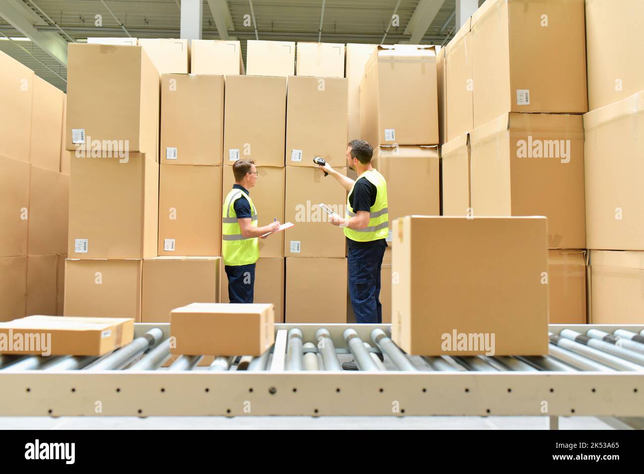 Worker in a warehouse in the logistics sector processing packages on ...