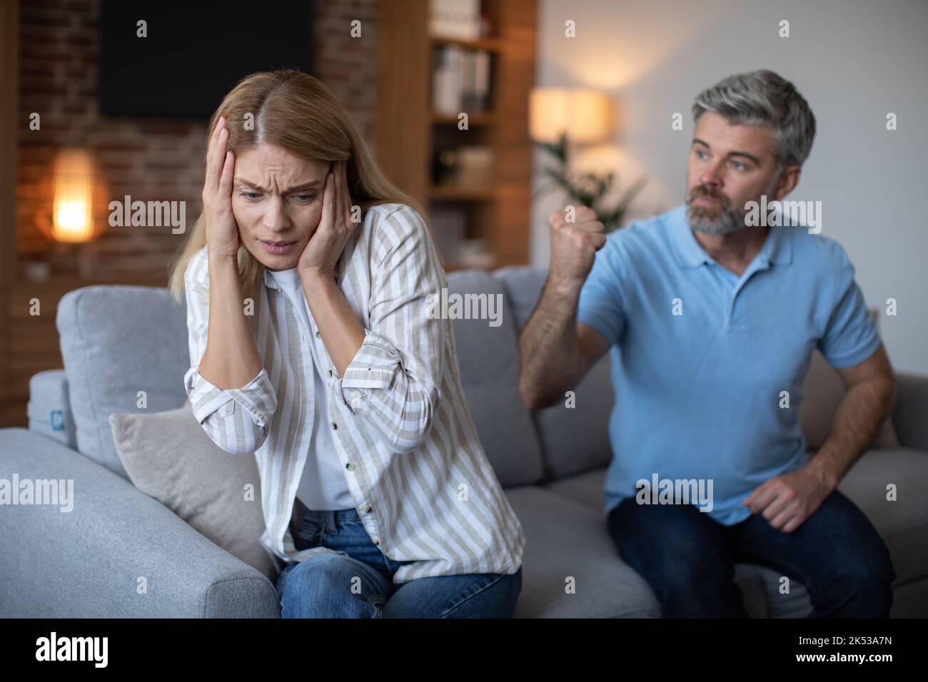 Aggressive angry mature caucasian husband threatens to frightened ...