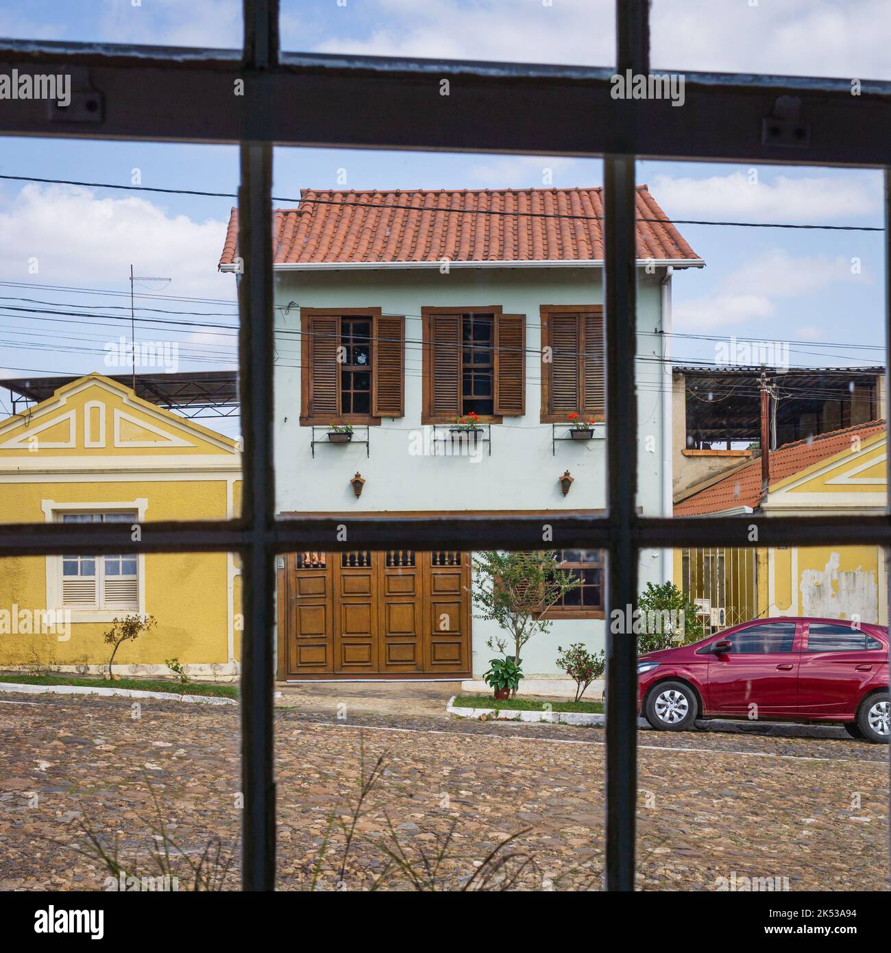 Window view of colonial homes with double-hung windows and street with ...