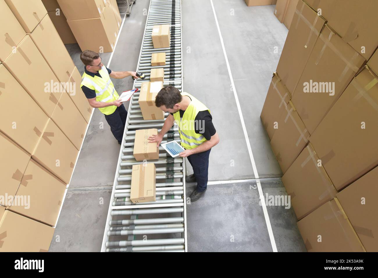 Worker in a warehouse in the logistics sector processing packages on ...
