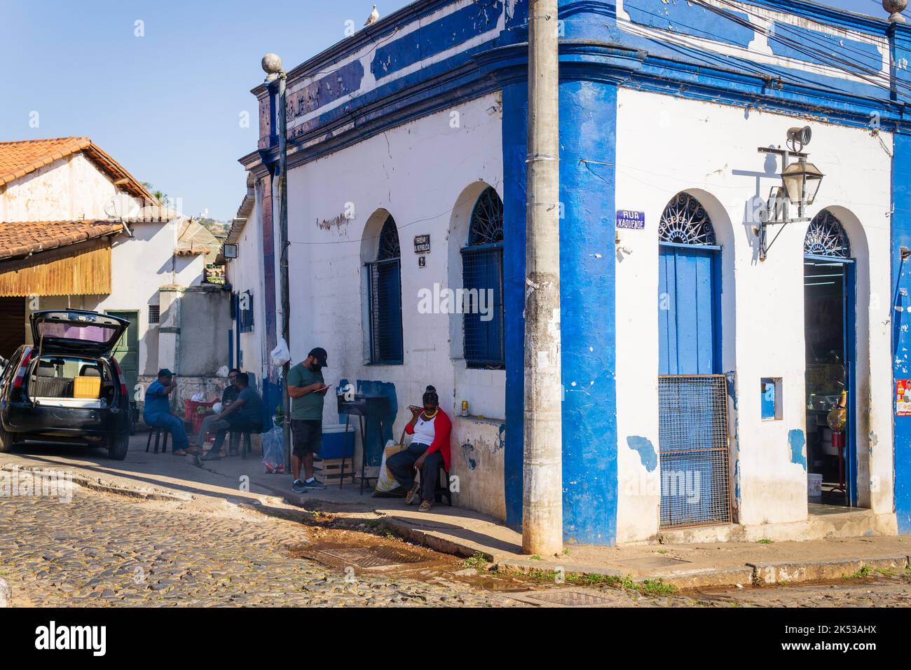 Local Brazilian people gathered outside of a colonial building cooking ...