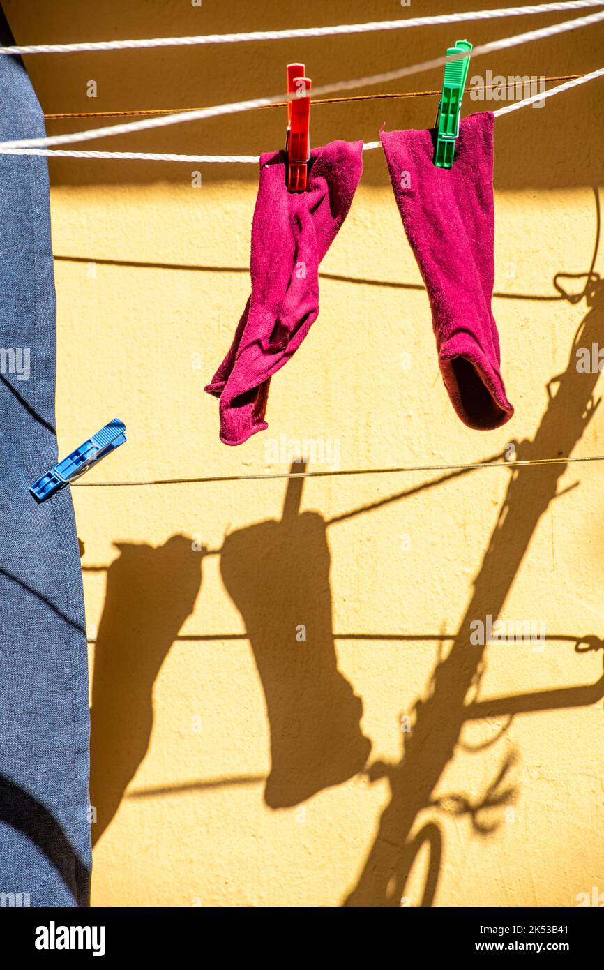 pair of pink socks on a washing line drying in the sunshine out of ...