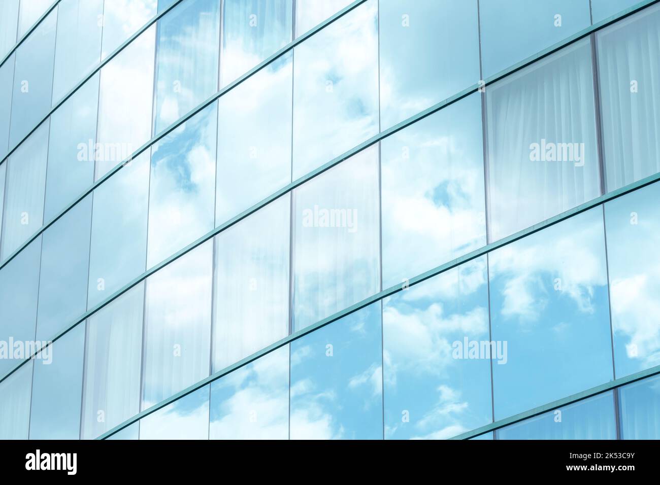 White clouds reflecting in simple modern generic office building square ...