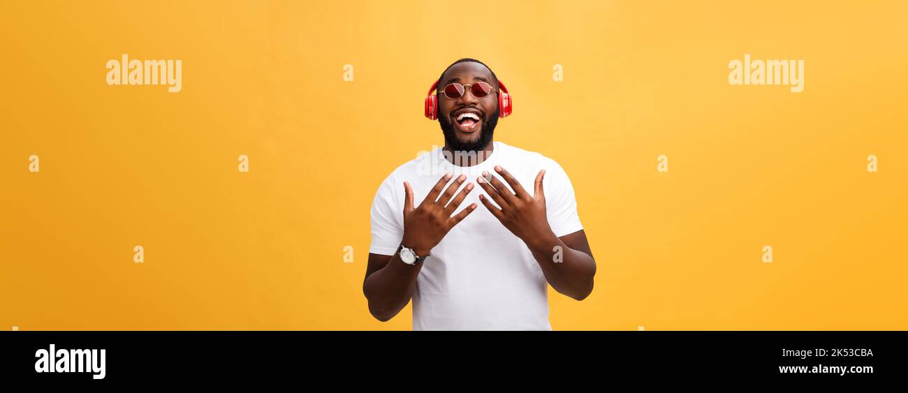 Handsome young African American man listening and smiling with music on ...
