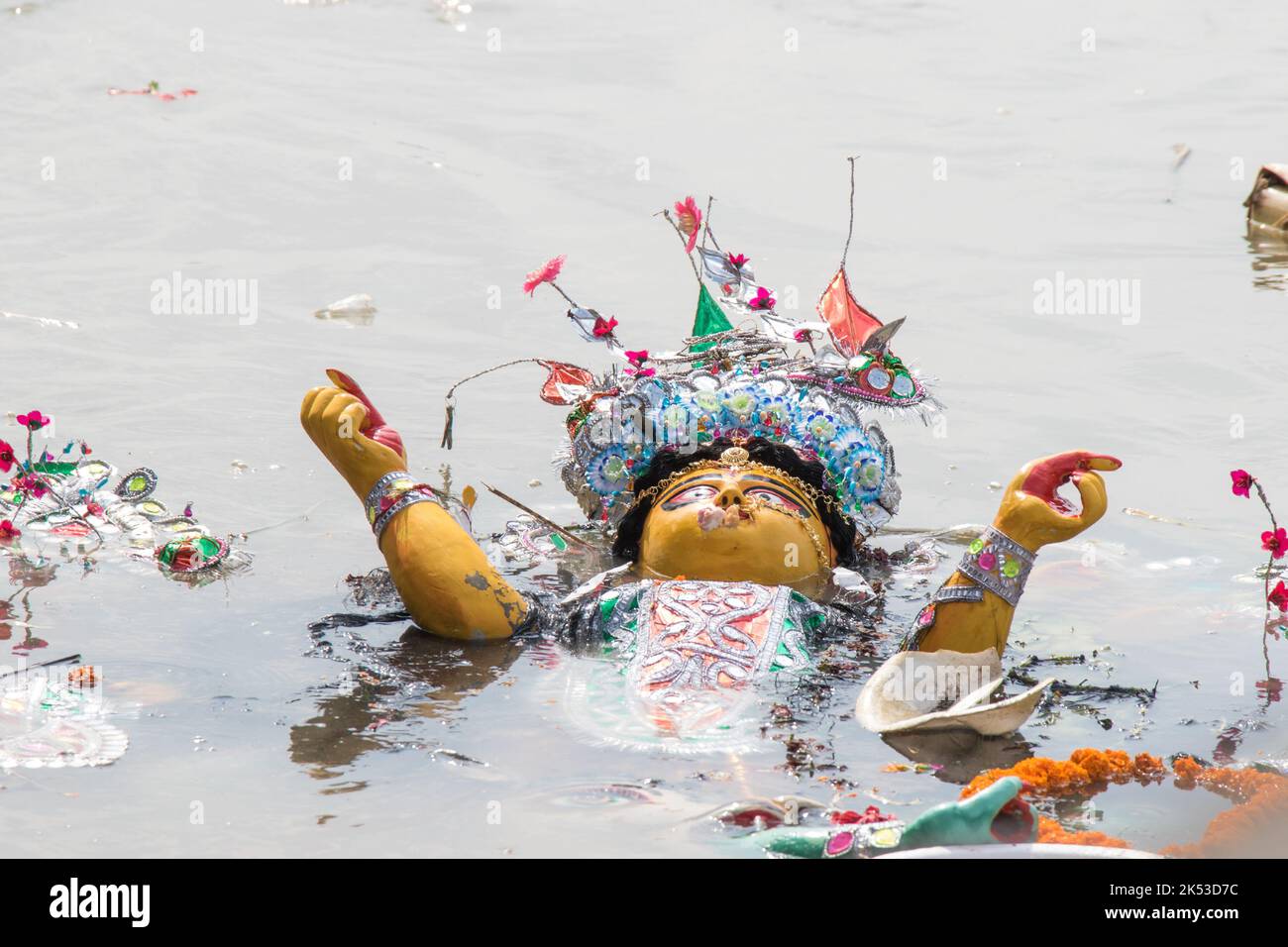 Idol of Goddess Durga is being immersed at holy river Ganges, at the ...