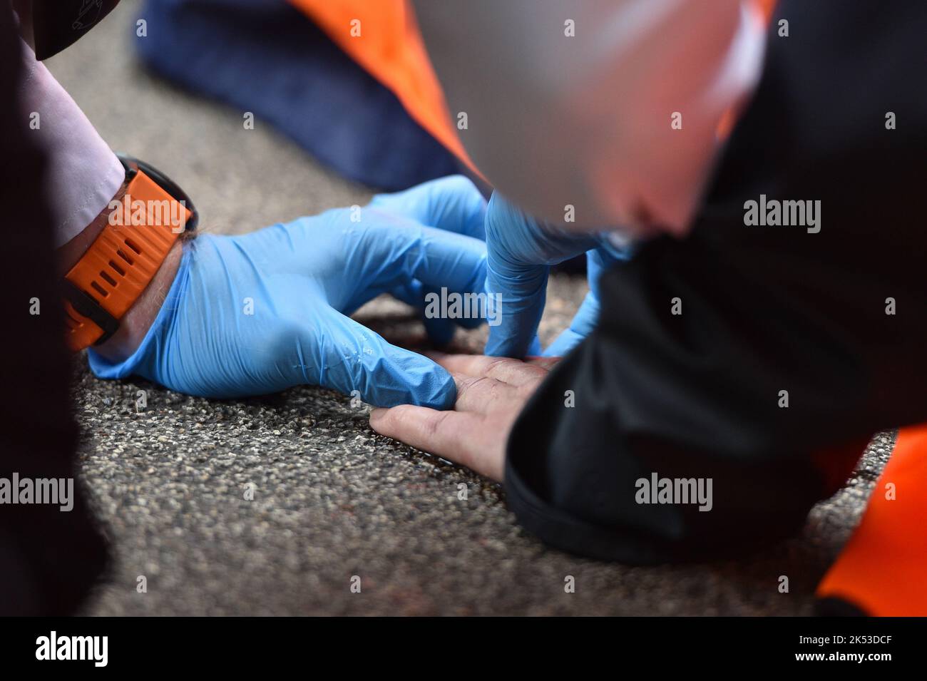 London, UK. 05th Oct, 2022. Protesters glued their hands to the street ...