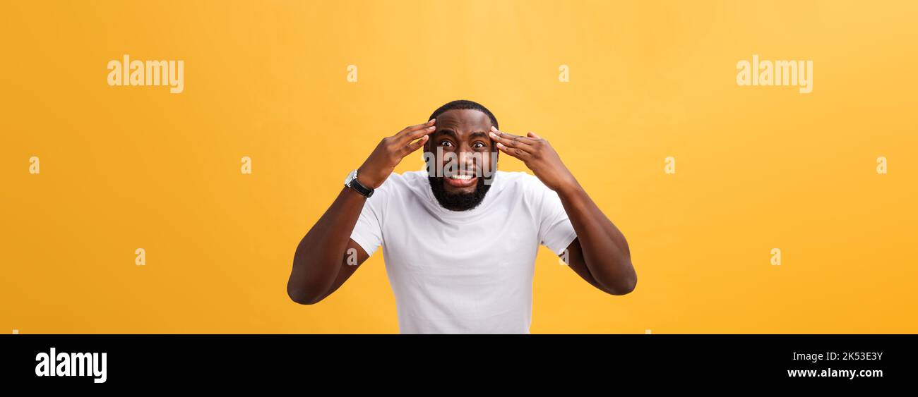 Portrait of african american man with hands raised in shock and ...