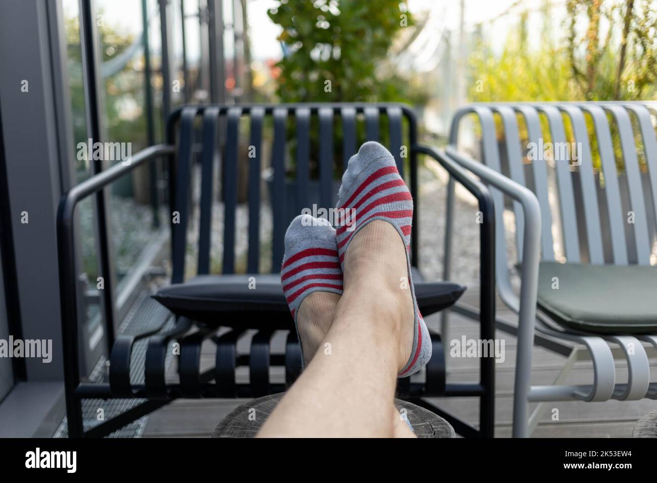 male legs in short socks stretched on the terrace Stock Photo - Alamy