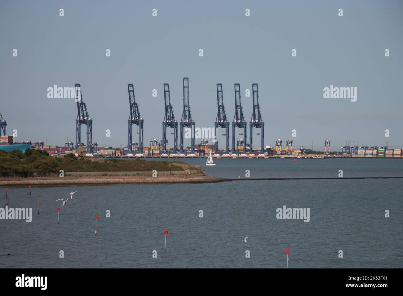 Large Cranes around the docks at Harwich with beaches and tourists in ...