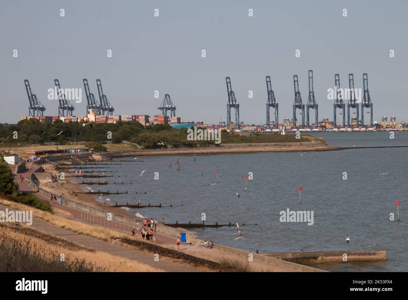 Large Cranes around the docks at Harwich with beaches and tourists in ...