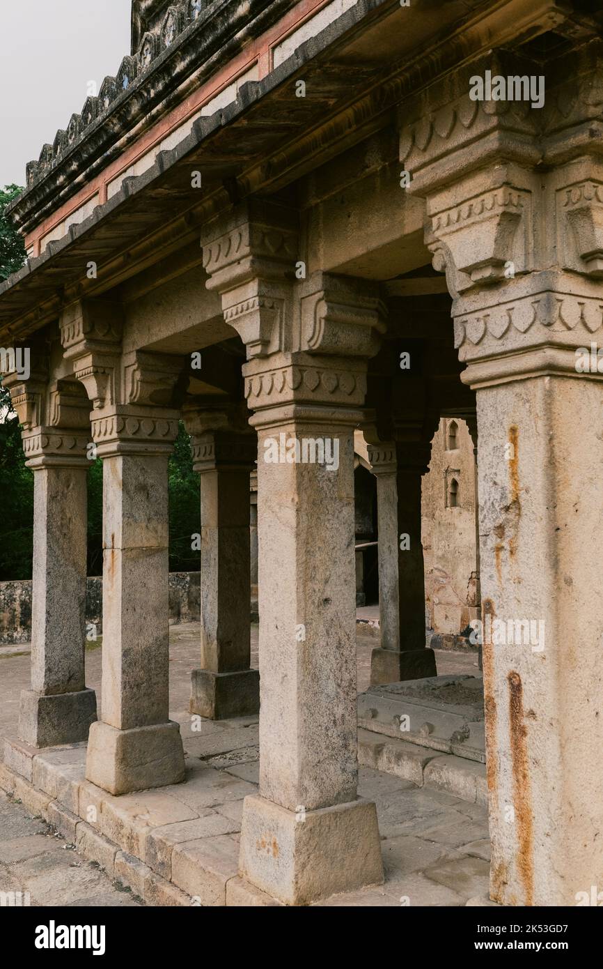 A vertical shot of columns of the Jamali Kamali mosque and tomb in New ...