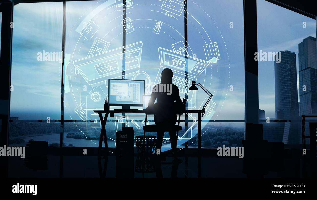 A woman web developer working at a computer in her office against the ...