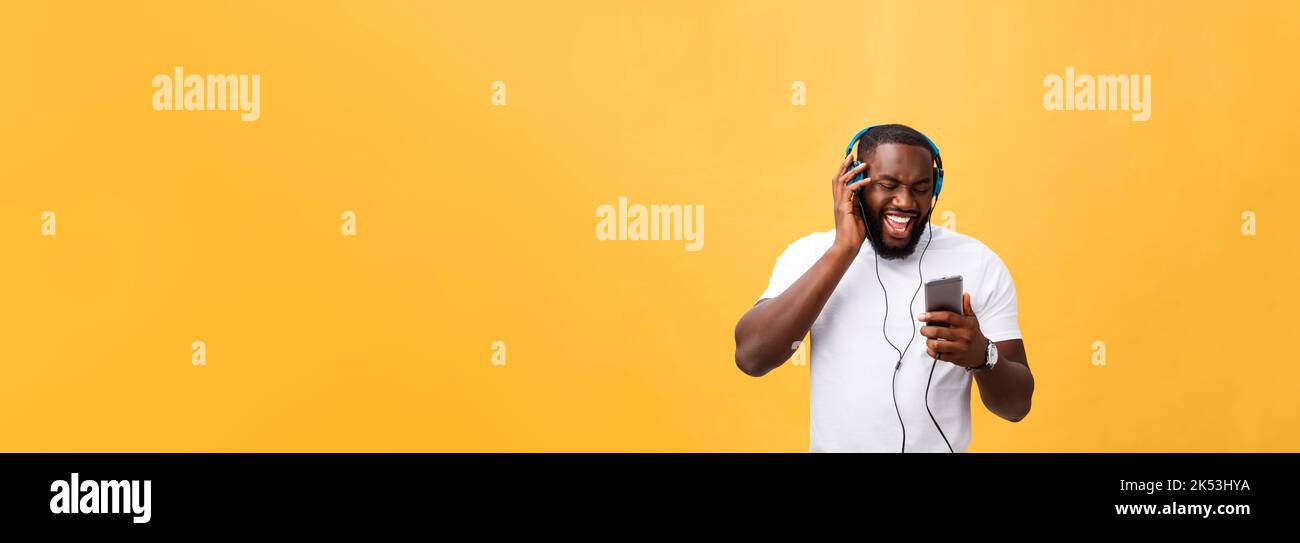 Young African American man wearing headphone and enjoy music over ...