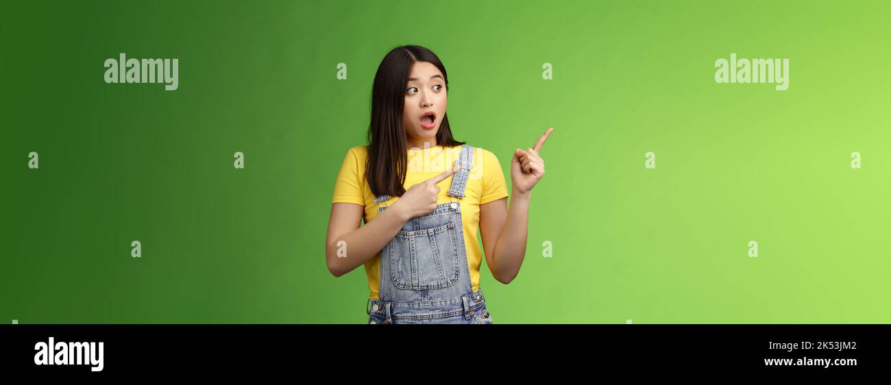 Shocked gasping alarmed pretty asian girl drop jaw impressed, turn ...