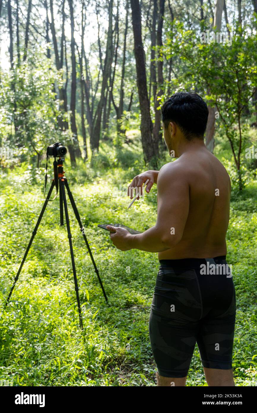 Guy with tablet making video blog on phone. Isolated person giving ...